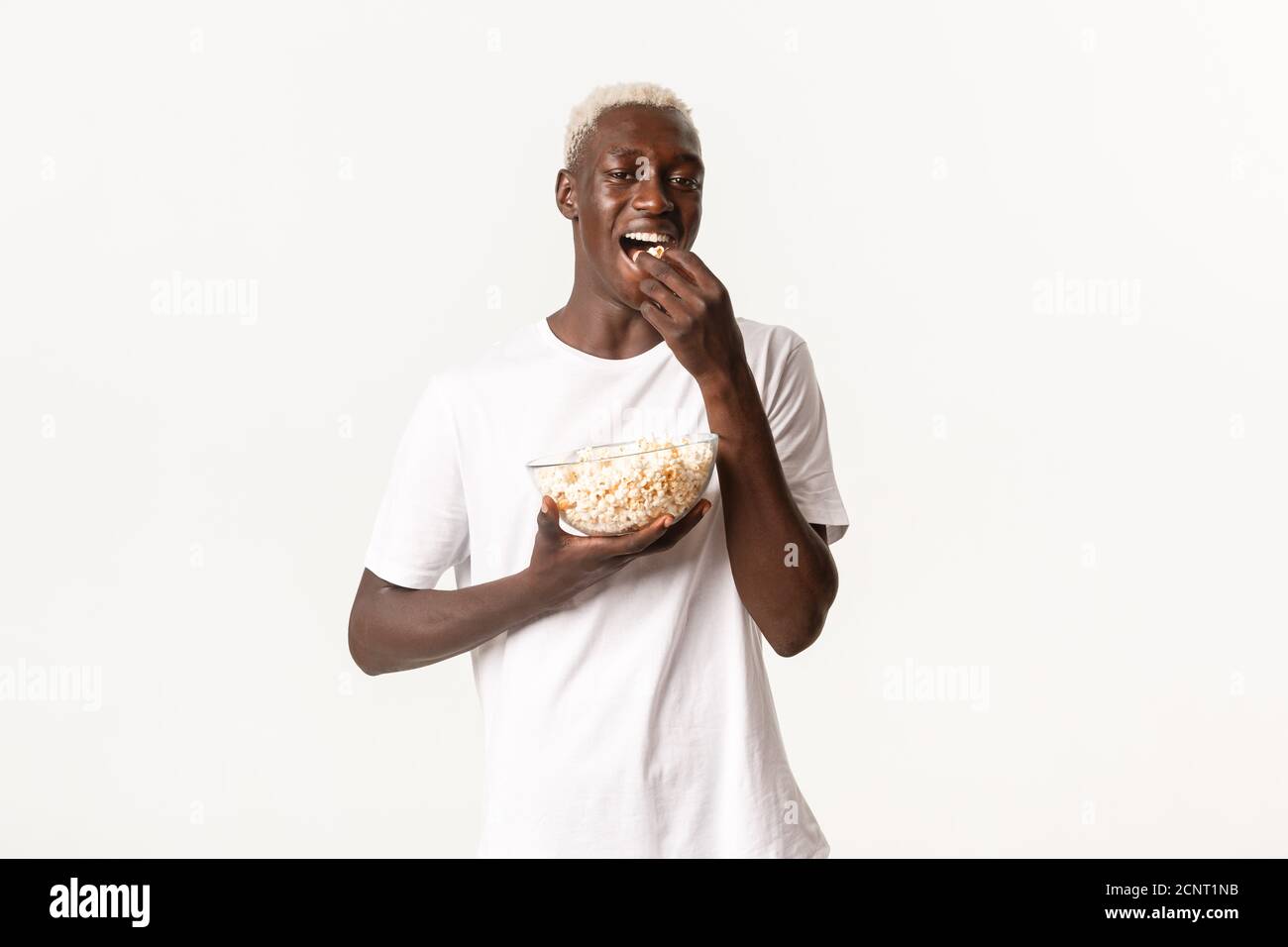 Portrait of handsome young african-american blond guy enjoying watching ...