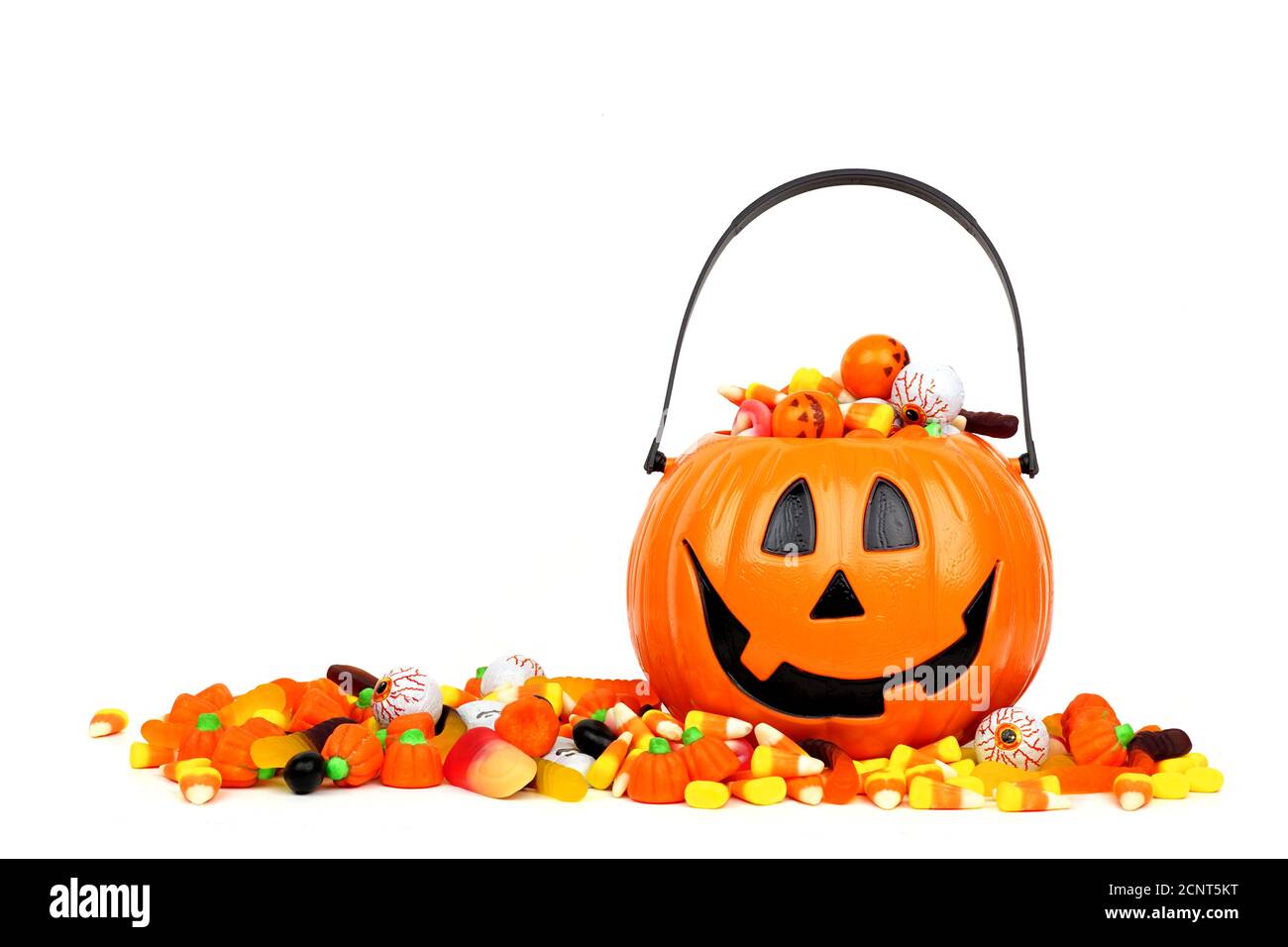 Halloween Jack o Lantern bucket overflowing with candy, side view ...