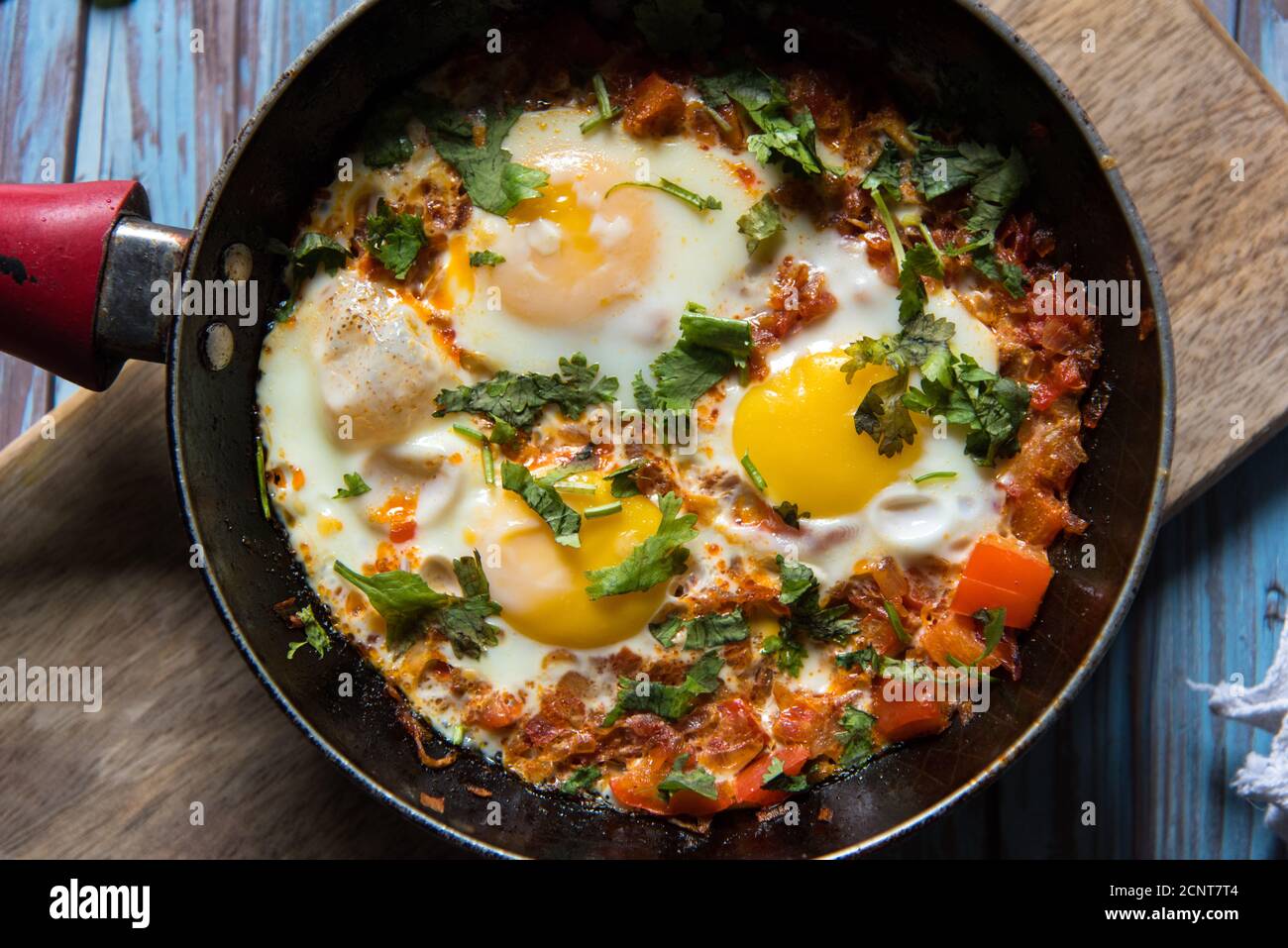 Top view of Shakshuka, a middle eastern delicacy in a black pan on a ...