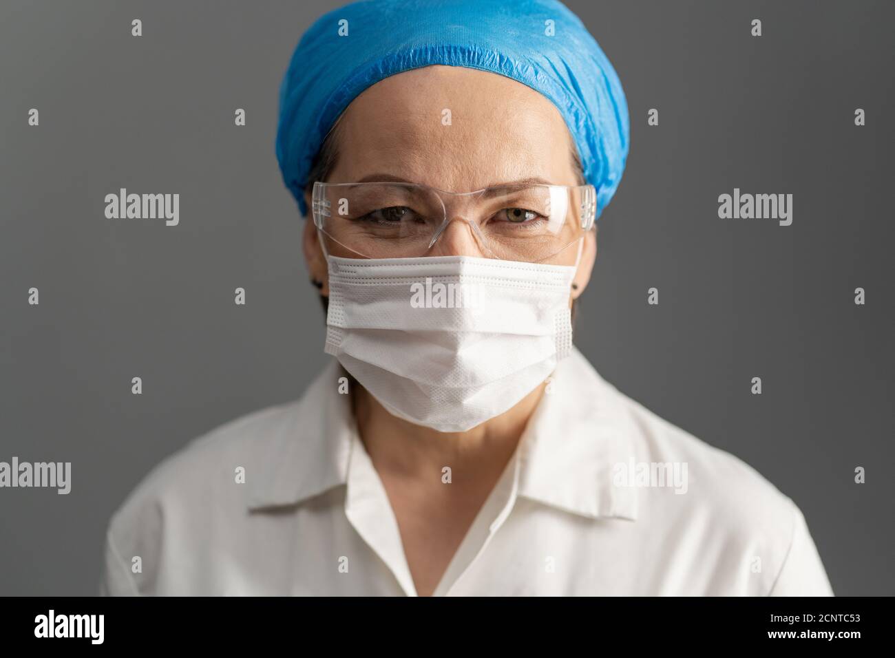 Female doctor face, close up shot. Mature woman in protective mask and ...