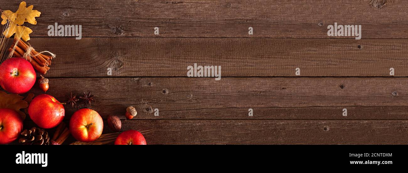 Autumn corner border banner of apples and fall ingredients on a rustic ...