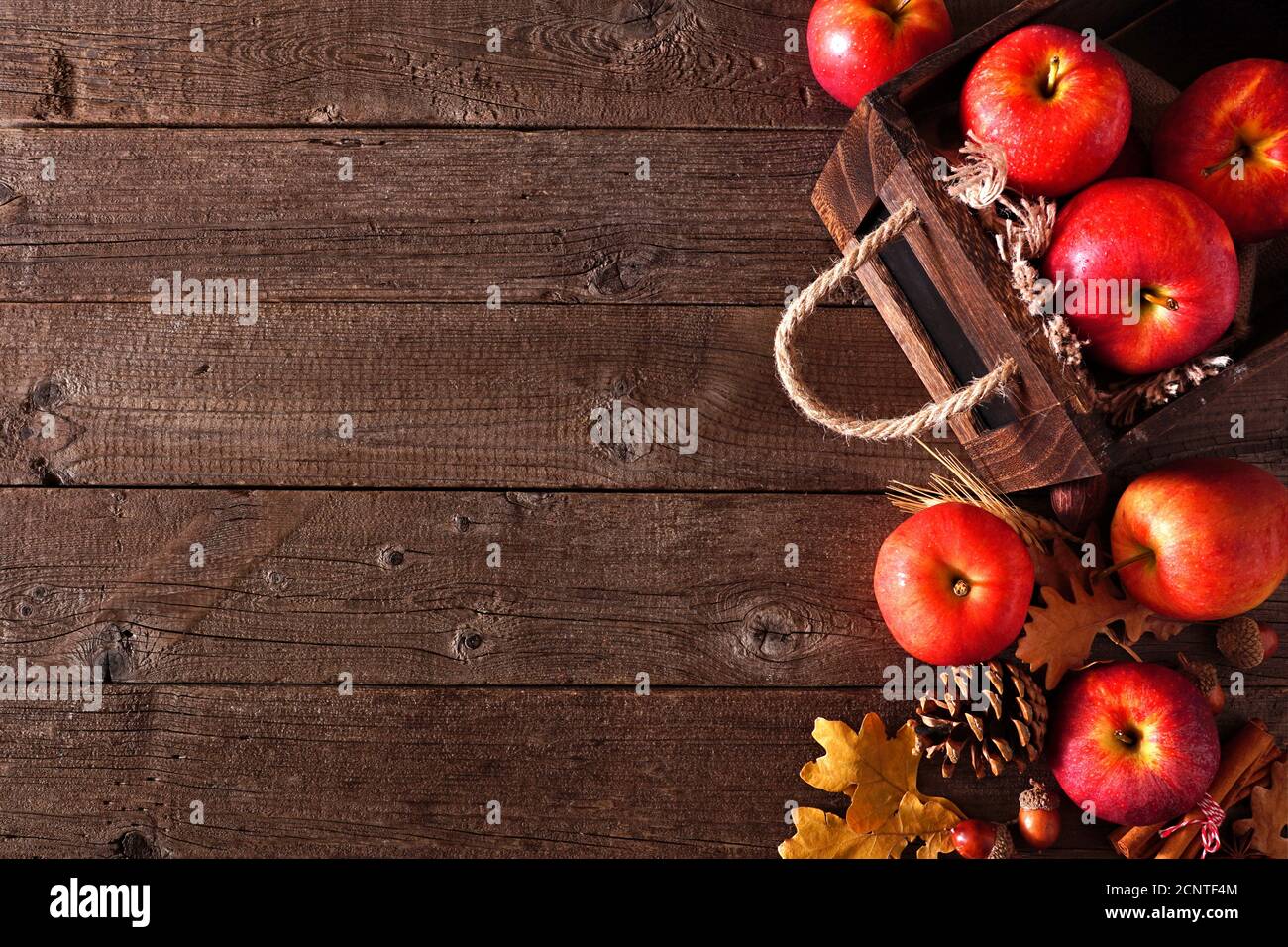 Autumn side border of apples and fall ingredients with crate on a ...