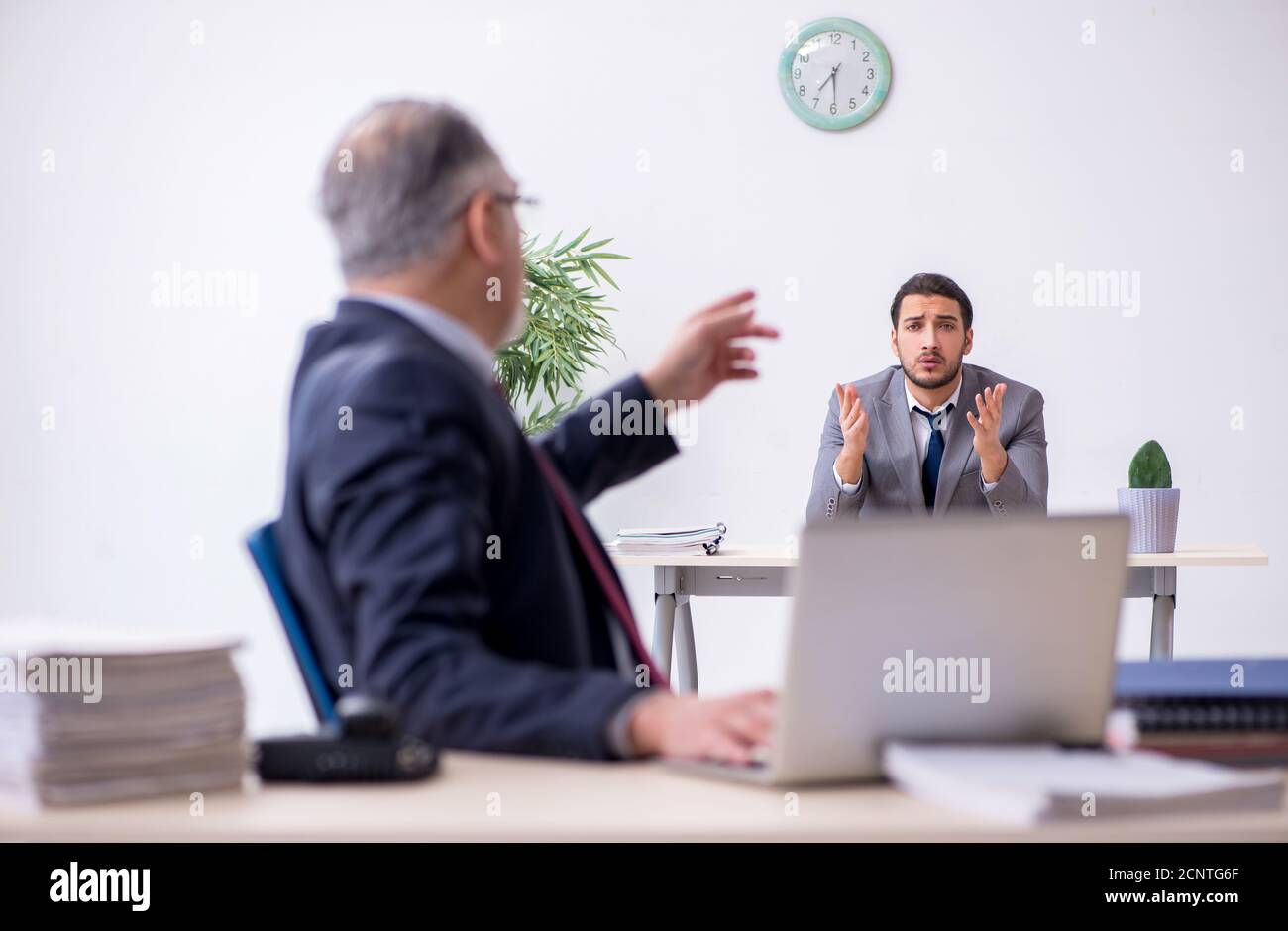 Old boss and his assistant working in the office Stock Photo - Alamy