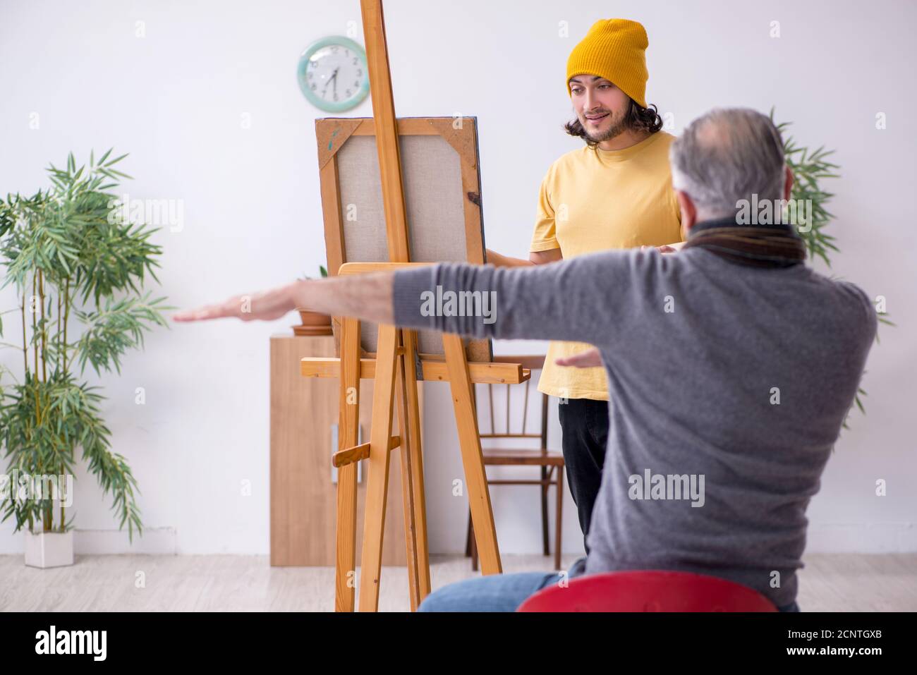 Young portraitist and old model Stock Photo - Alamy