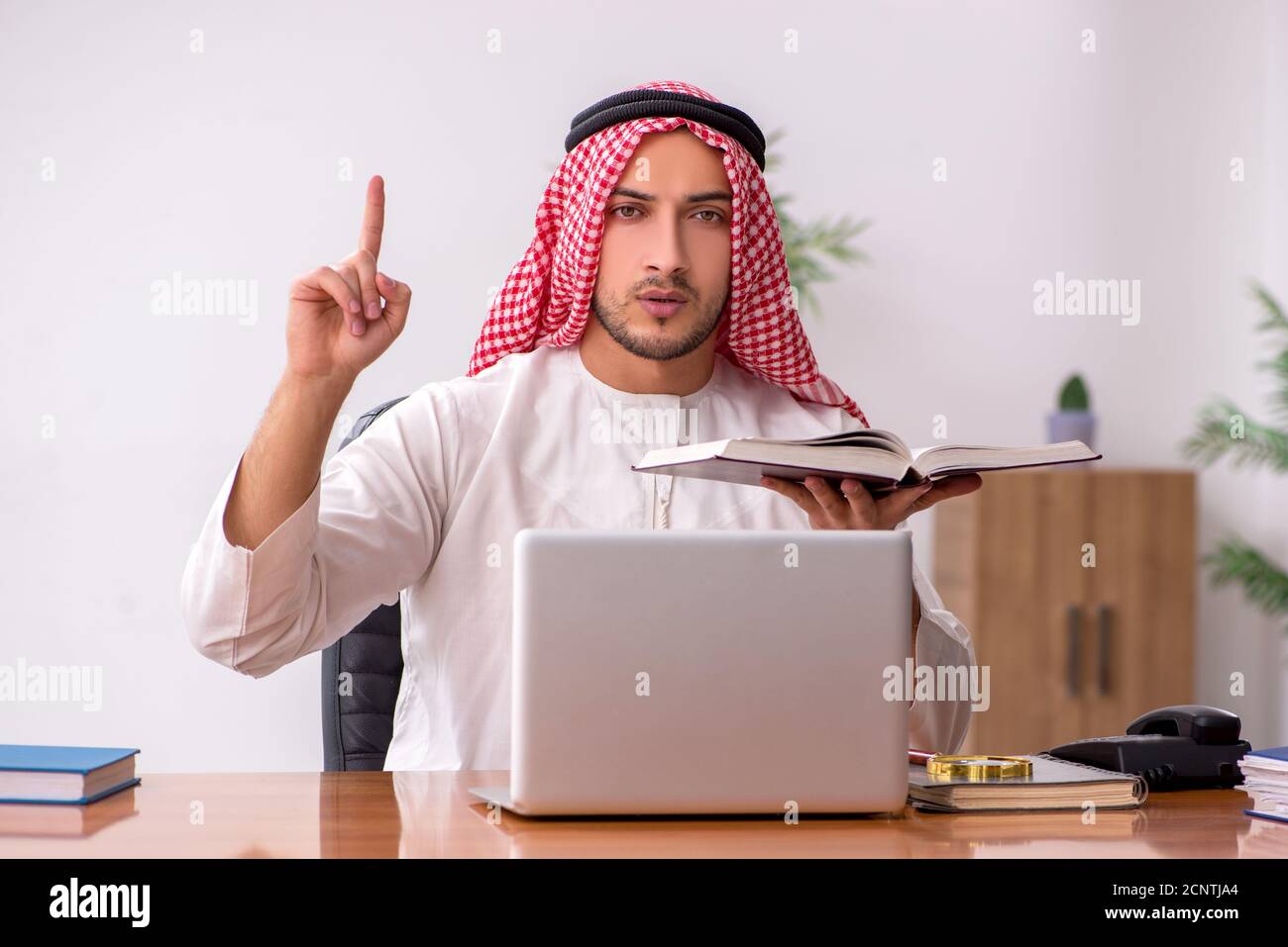 Male arab employee working in the office Stock Photo - Alamy