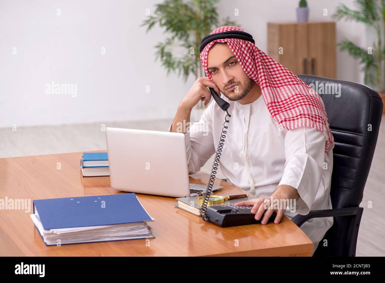Male arab employee working in the office Stock Photo - Alamy