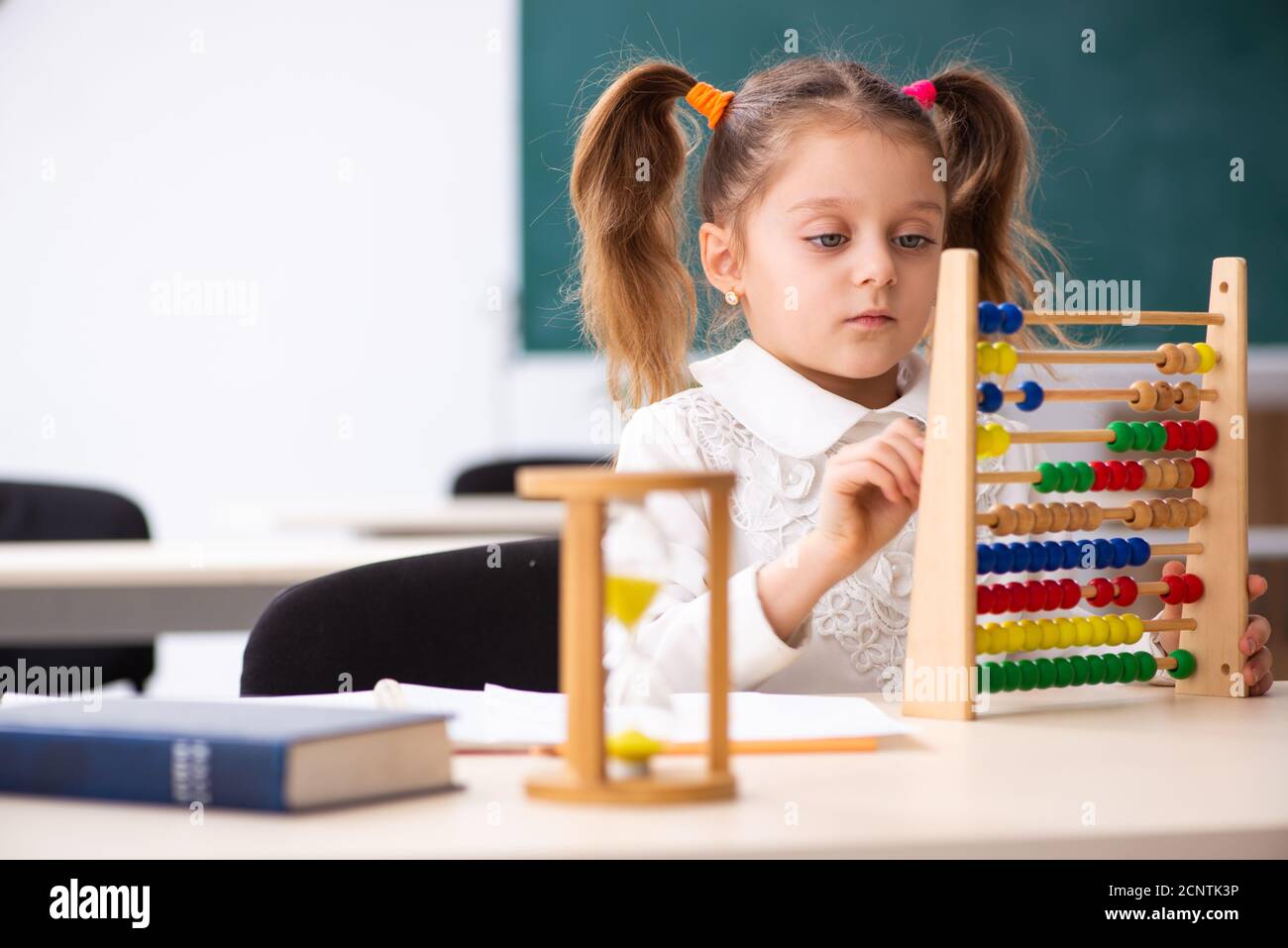 Small girl with the abacus in the classroom Stock Photo - Alamy