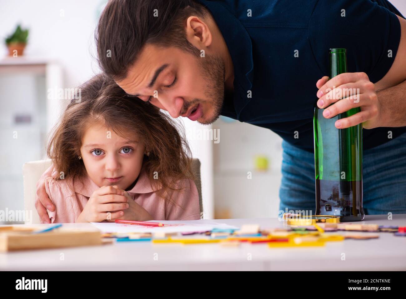 Drunk father and little girl at home Stock Photo - Alamy