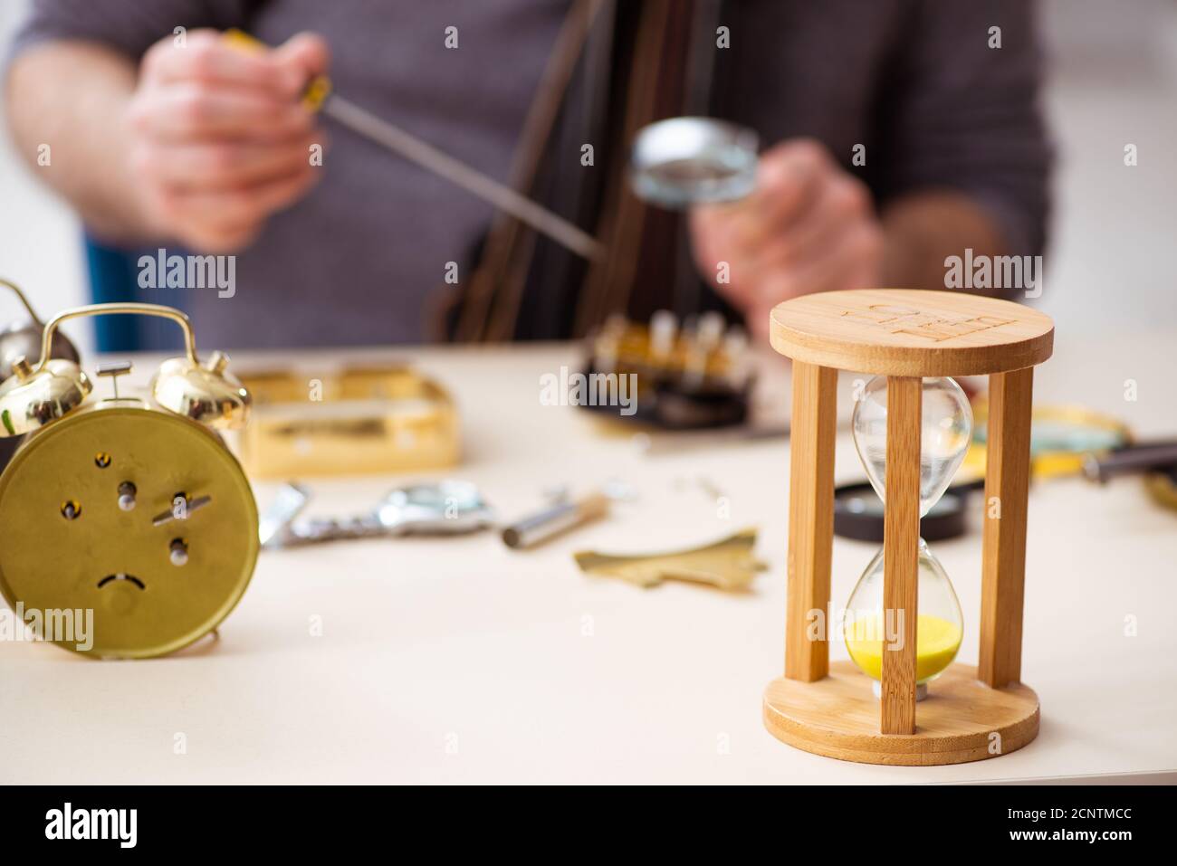 Old watchmaker working in the workshop Stock Photo - Alamy