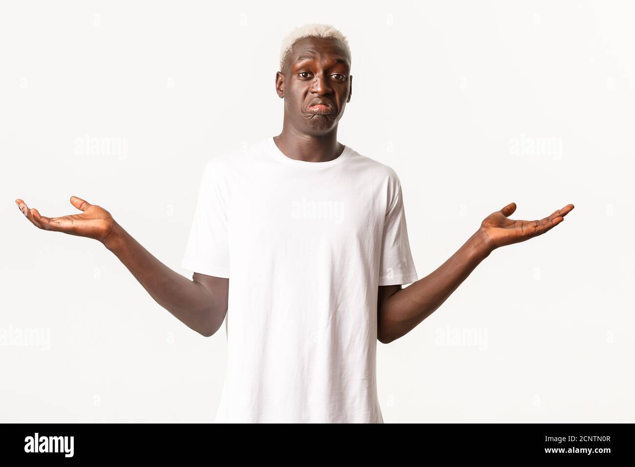 Portrait of clueless attractive african-american blond male, spread ...