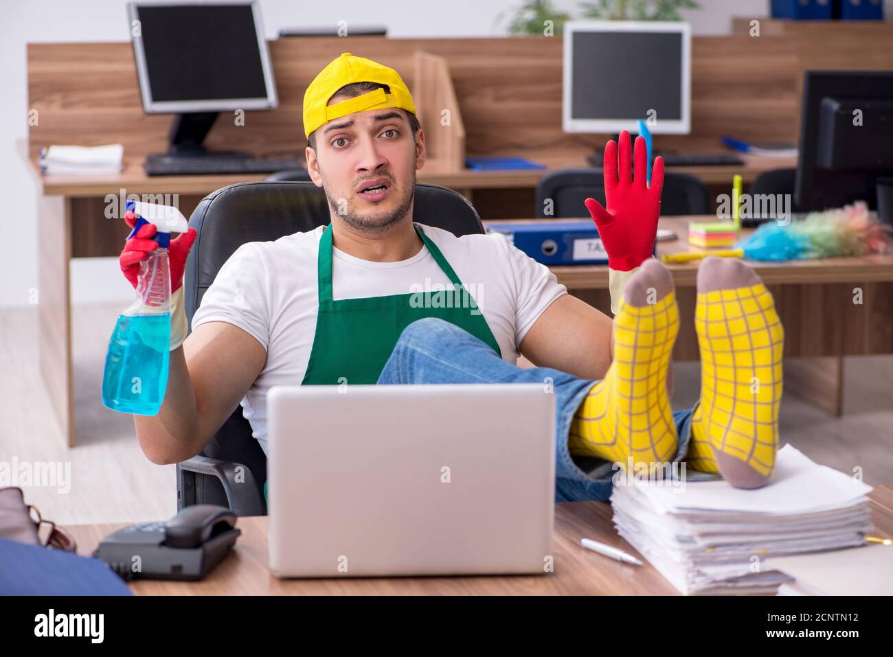 Young contractor cleaning the office Stock Photo - Alamy