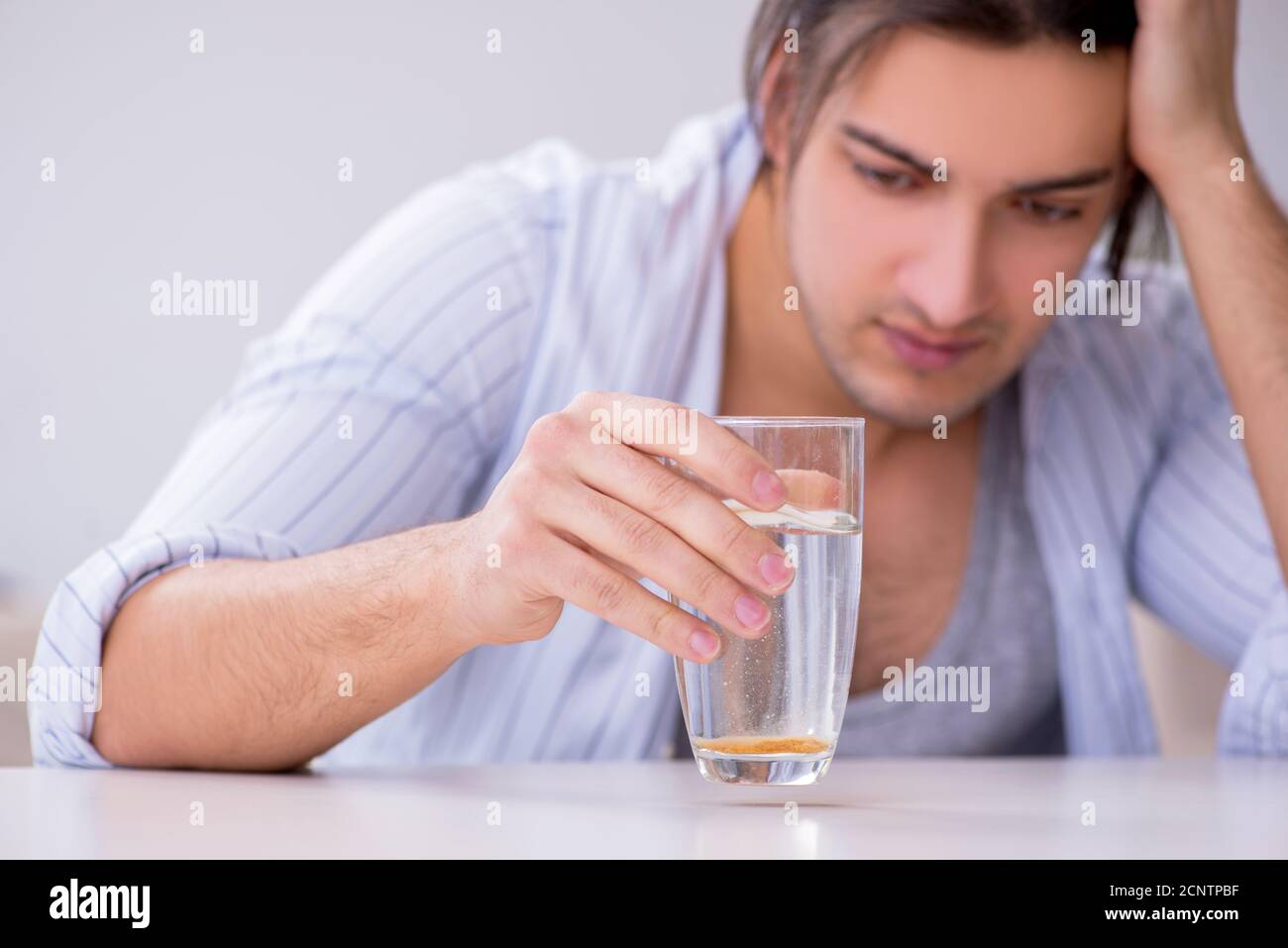 Male alcoholic drinking whiskey at home Stock Photo - Alamy