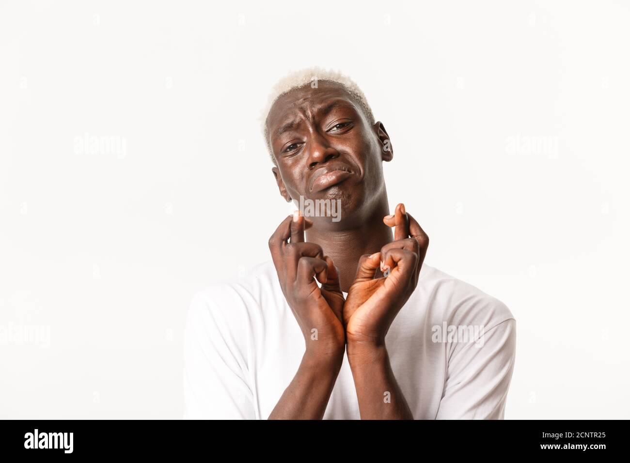 Close-up of miserable whining african-american blond guy, pleading or ...