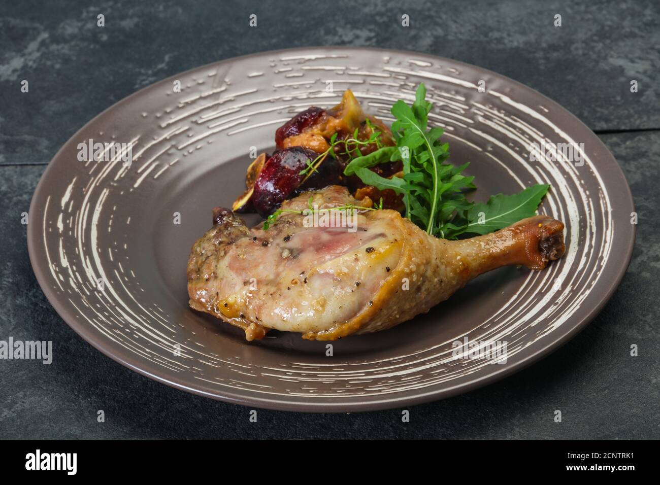 Roasted. duck. leg with plum, fig and apple Stock Photo - Alamy