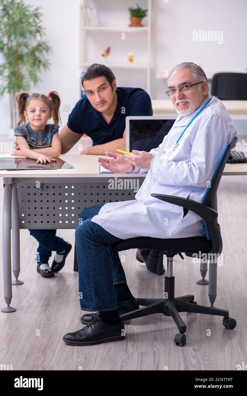 Young father and his daughter visiting old doctor Stock Photo - Alamy