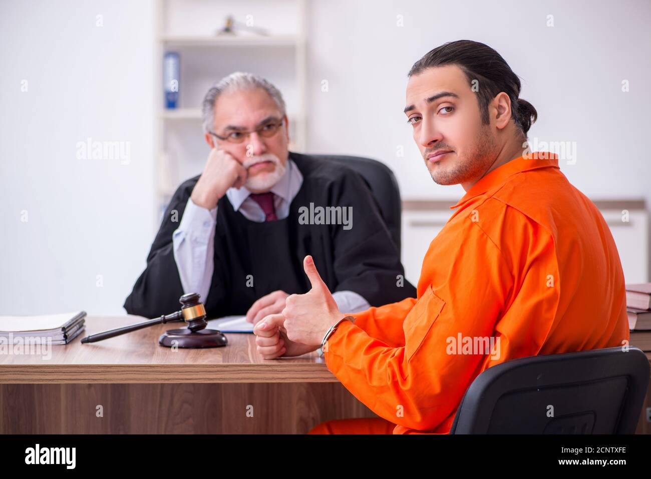 Old judge meeting with young captive in courthouse Stock Photo - Alamy