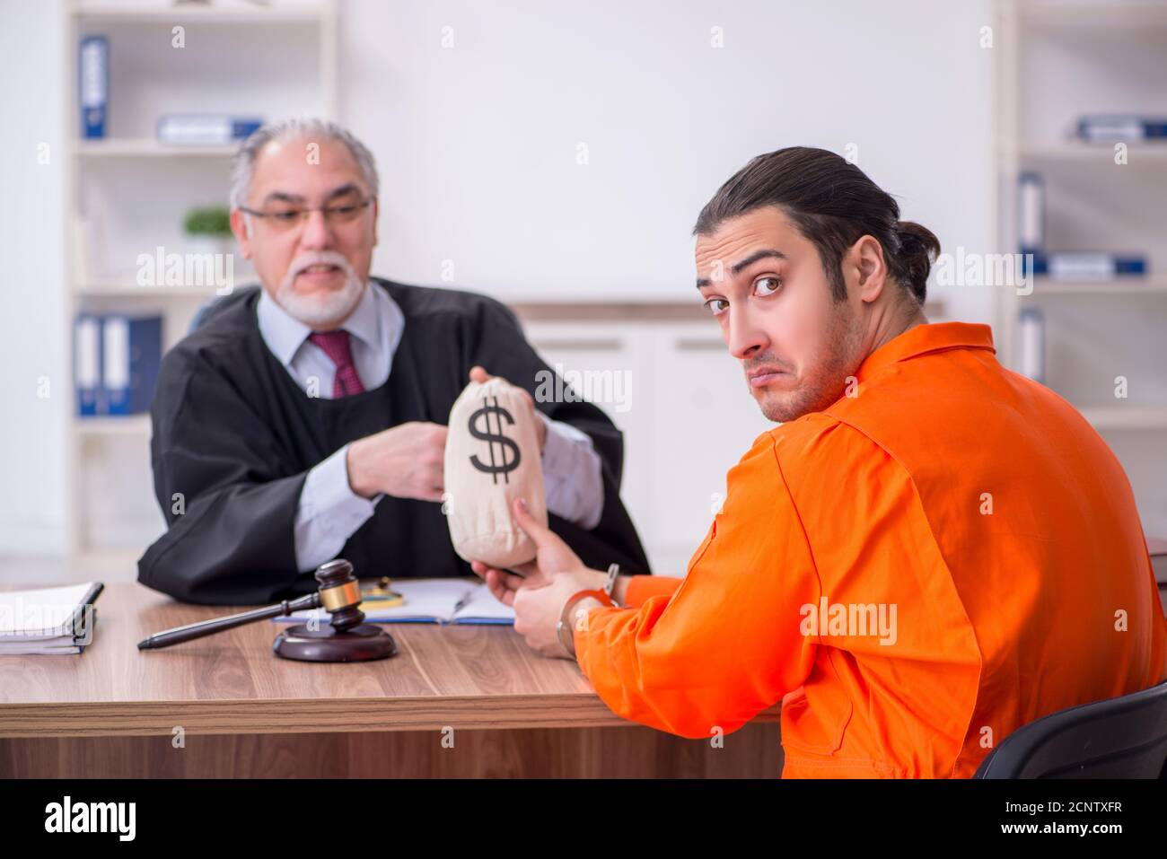 Old judge meeting with young captive in courthouse Stock Photo - Alamy