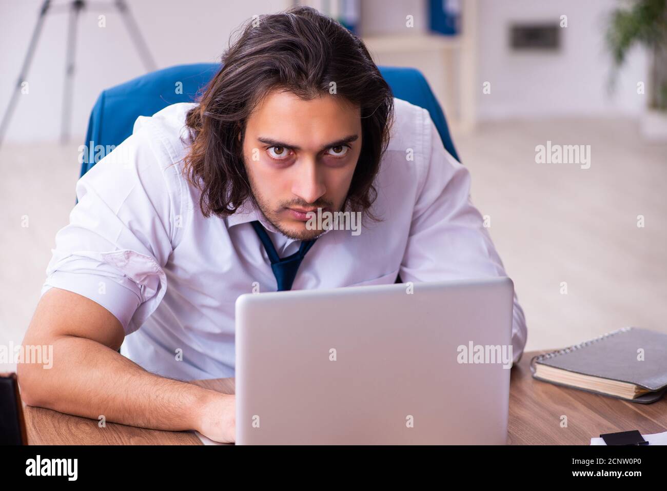 Drug addicted employee working in the office Stock Photo - Alamy