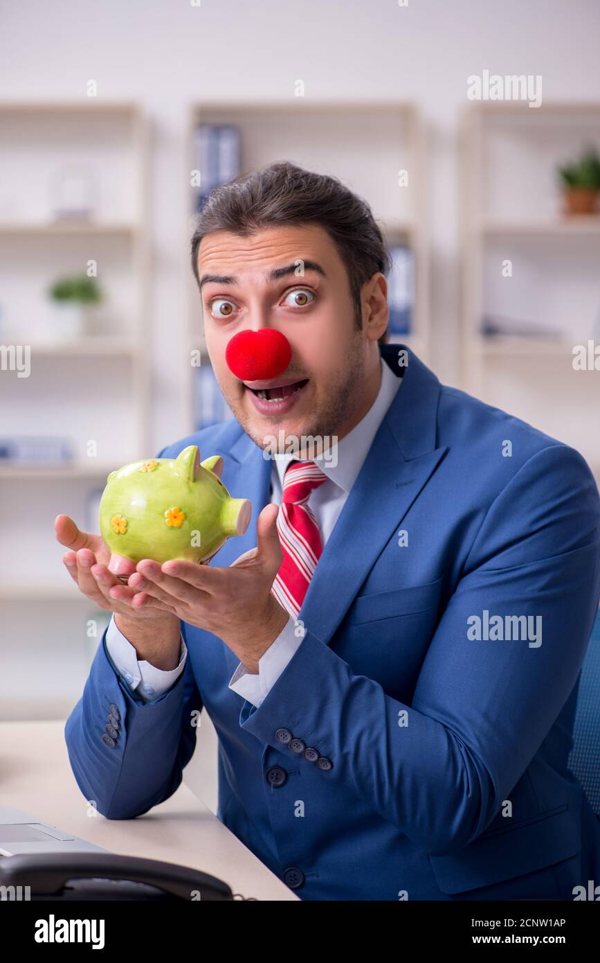 Funny employee clown working in the office room Stock Photo - Alamy