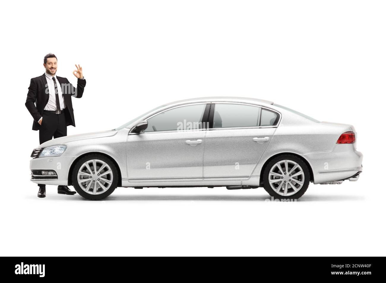 Businessman with a silver car and showing an ok sign isolated on white ...