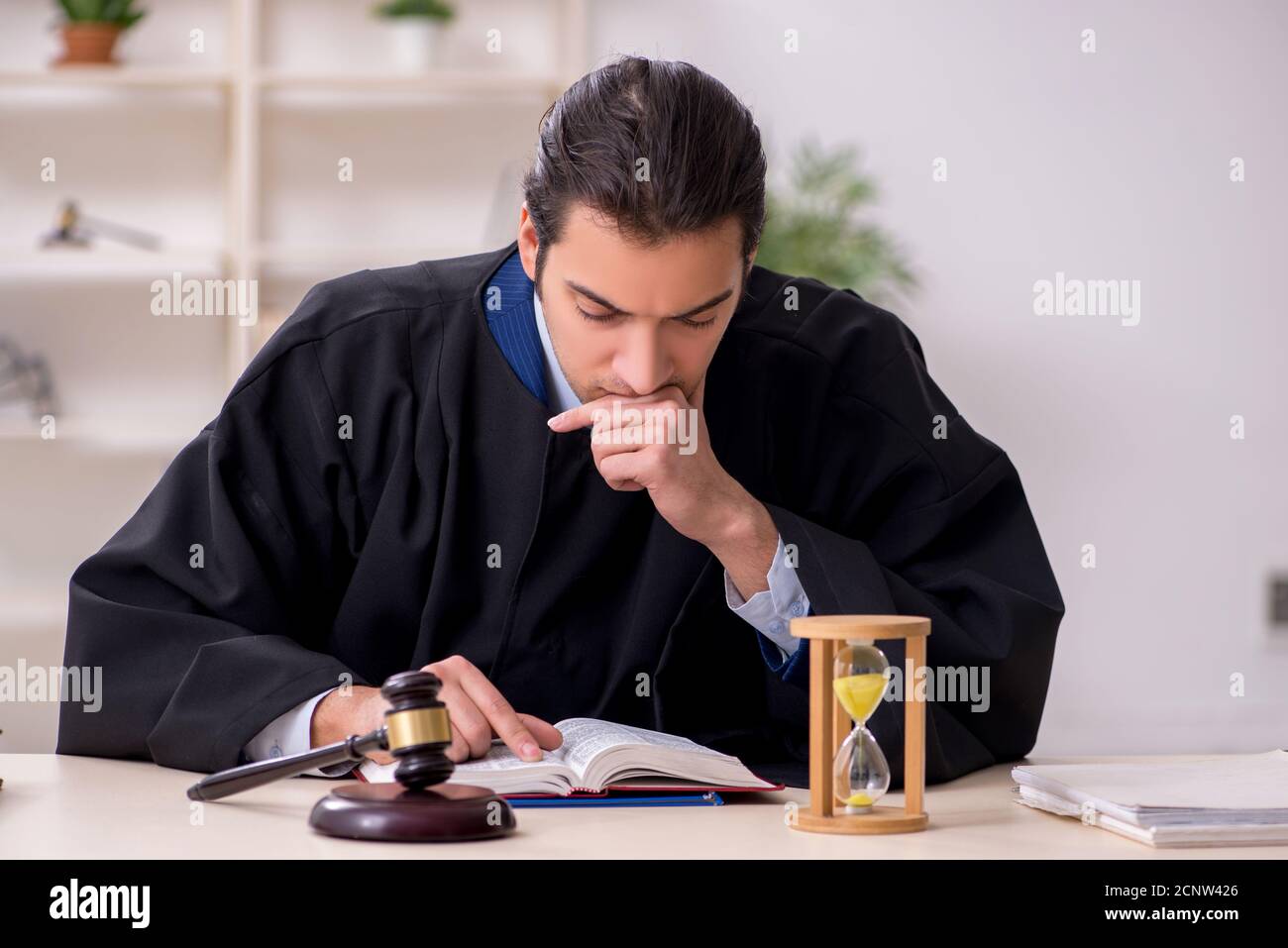 Young judge in time management concept Stock Photo - Alamy