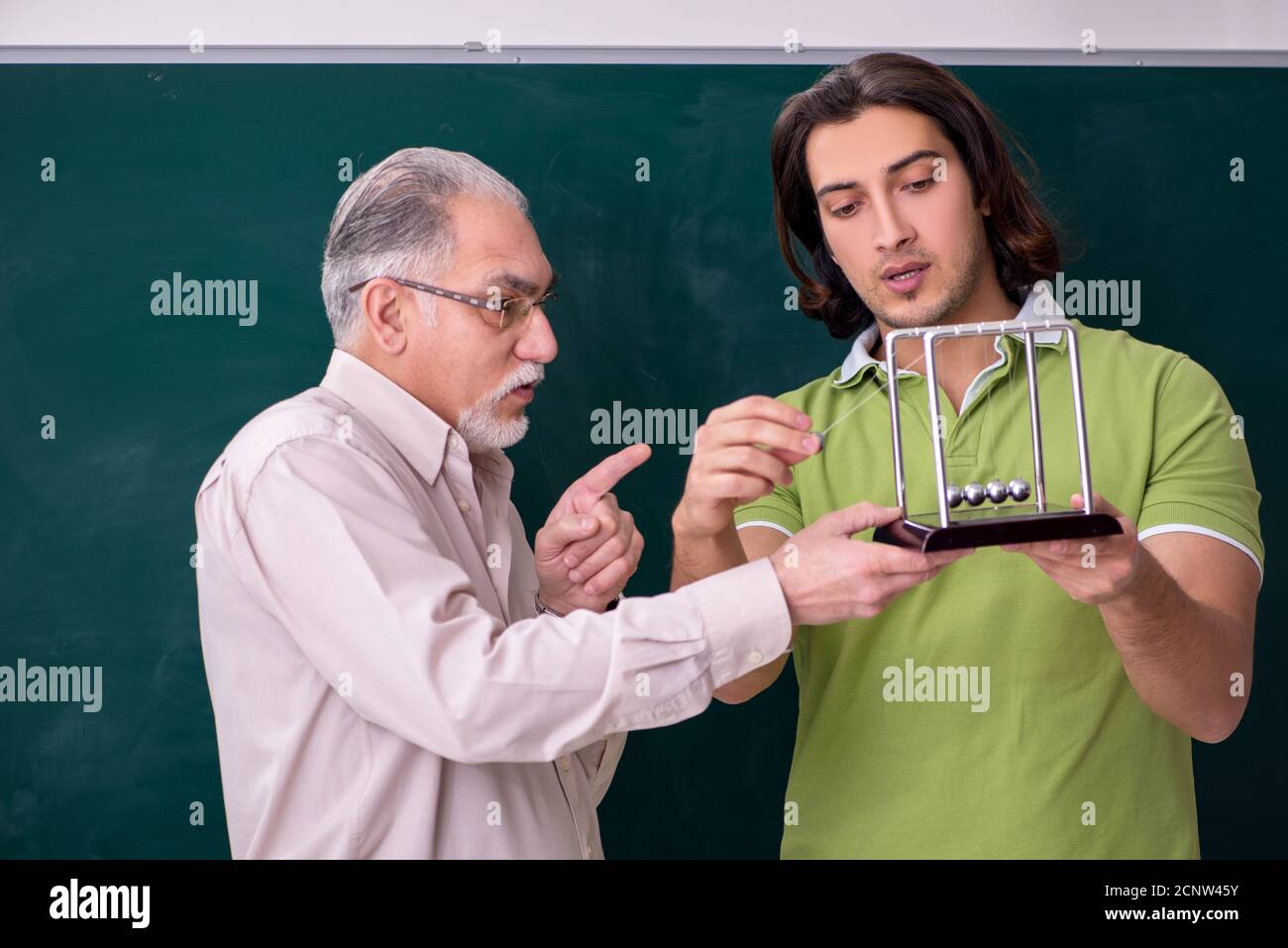 Old professor physicist and student in the classroom Stock Photo - Alamy