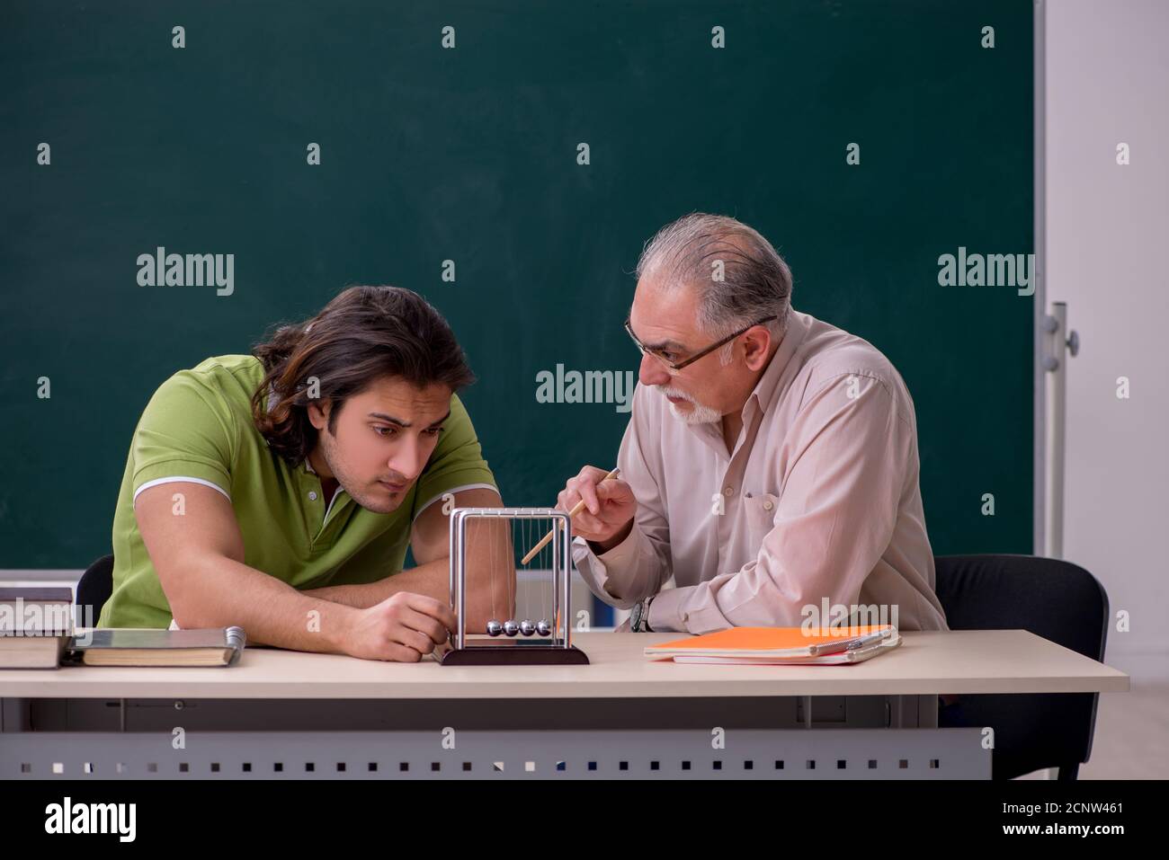 Old professor physicist and student in the classroom Stock Photo - Alamy