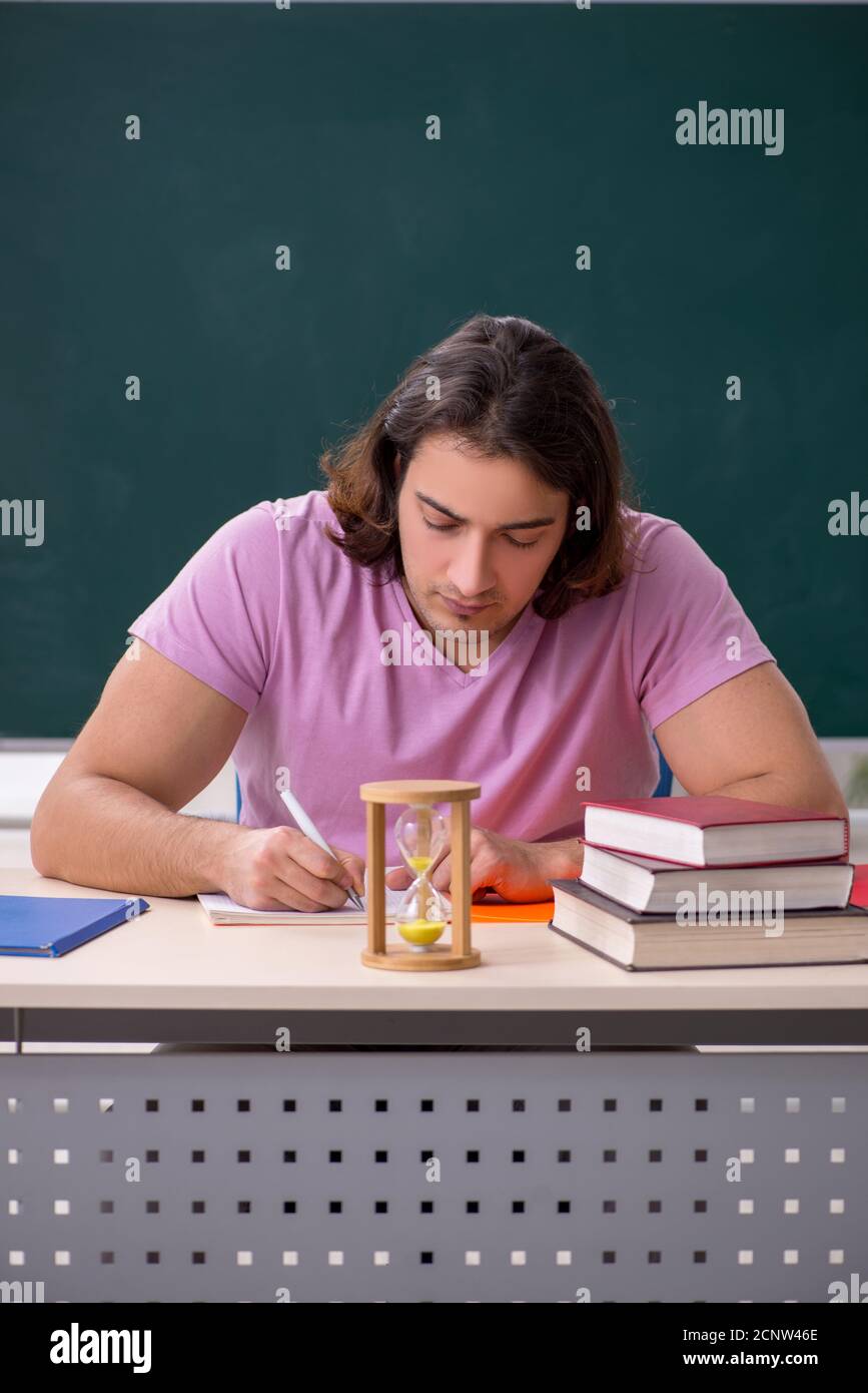 Young student in the classroom at time management concept Stock Photo ...