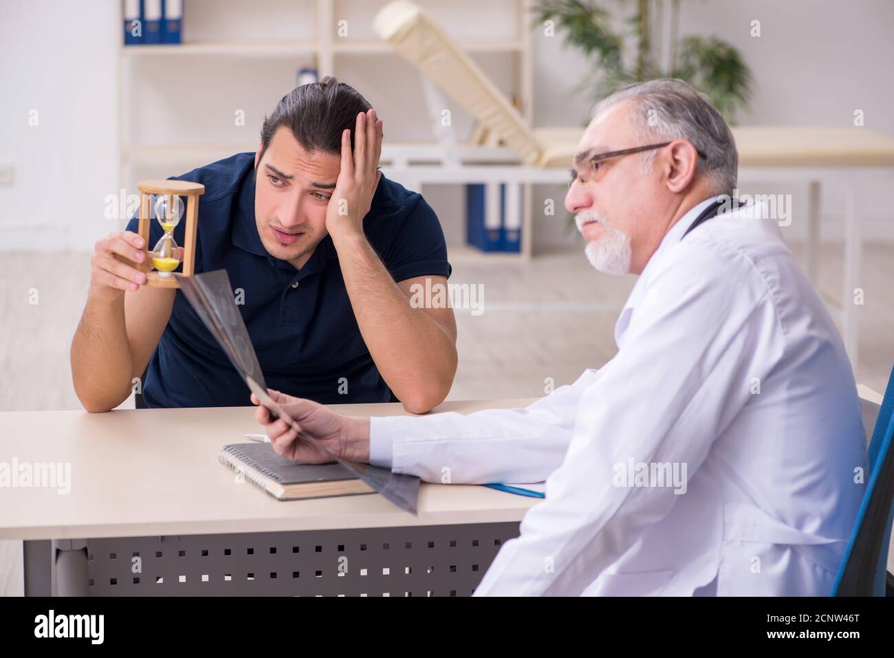 Male patient visiting doctor radiologist in time management concept ...