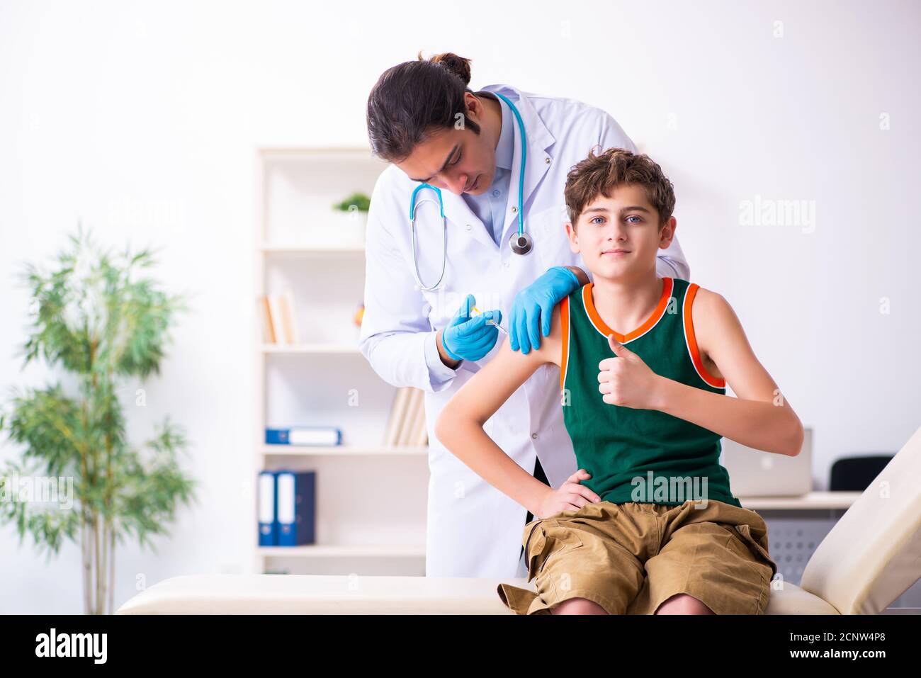 Sick boy visiting young doctor pediatrician Stock Photo - Alamy