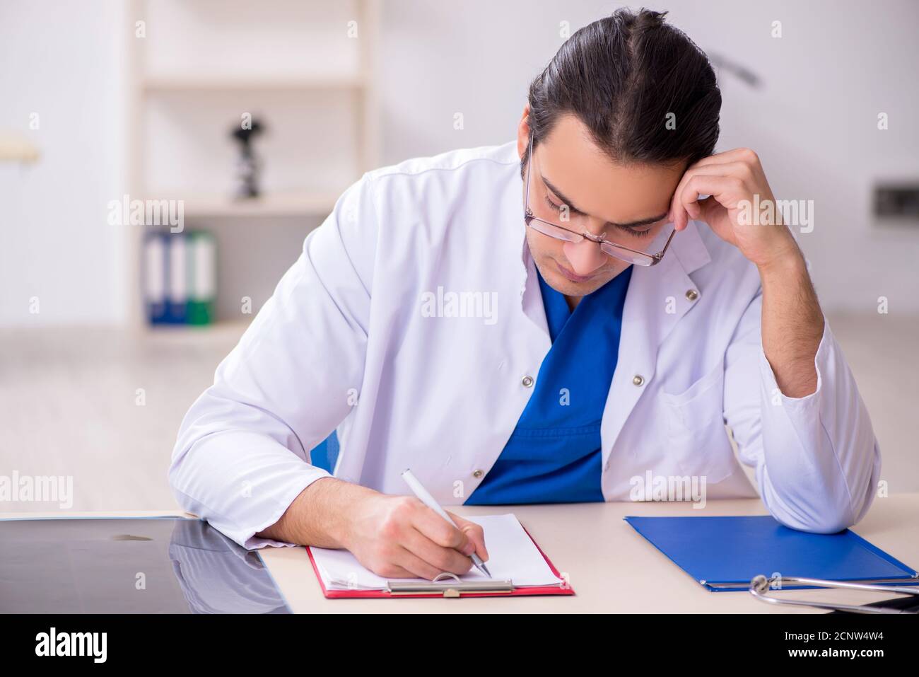 Young doctor working in hospital Stock Photo - Alamy