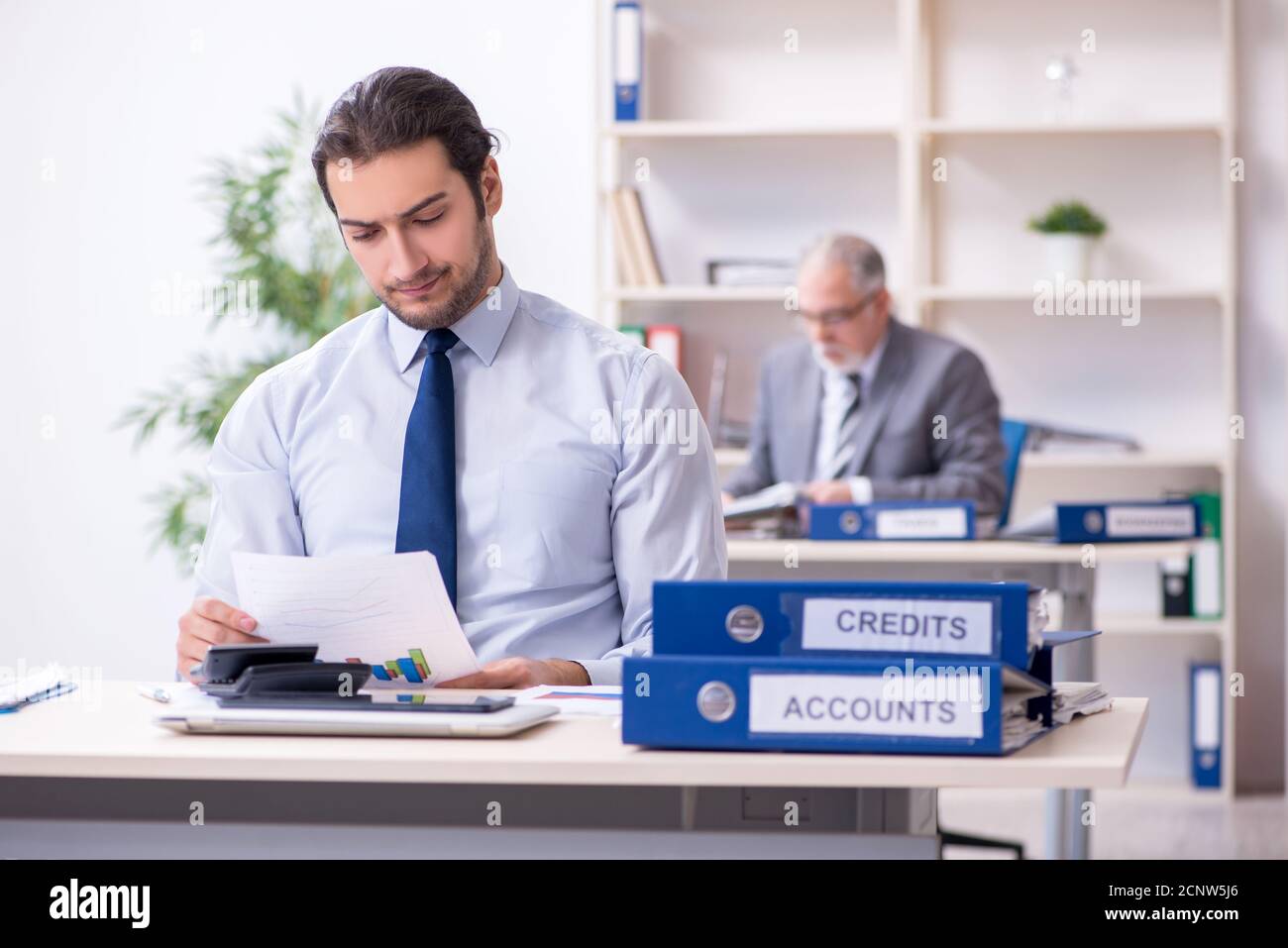 The two accountants working in the office Stock Photo - Alamy