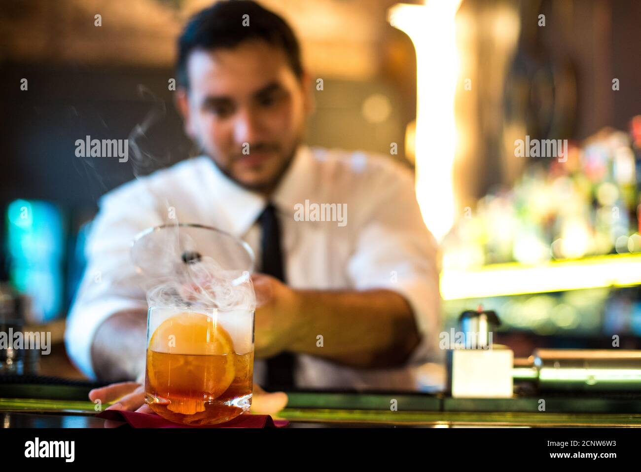 Bartender preparing and serving a special drink Stock Photo - Alamy