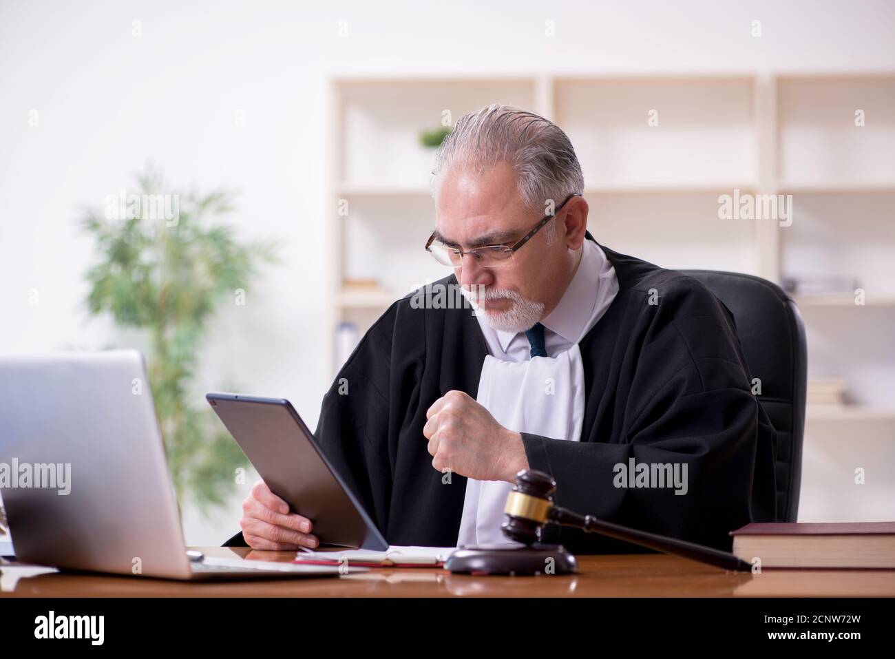 Old judge working in courthouse Stock Photo - Alamy