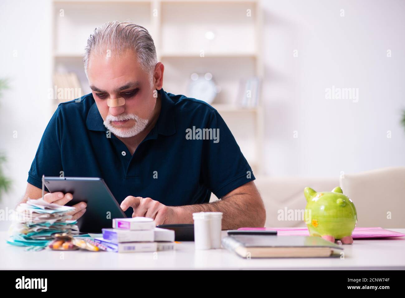 Old man in budget planning concept Stock Photo - Alamy