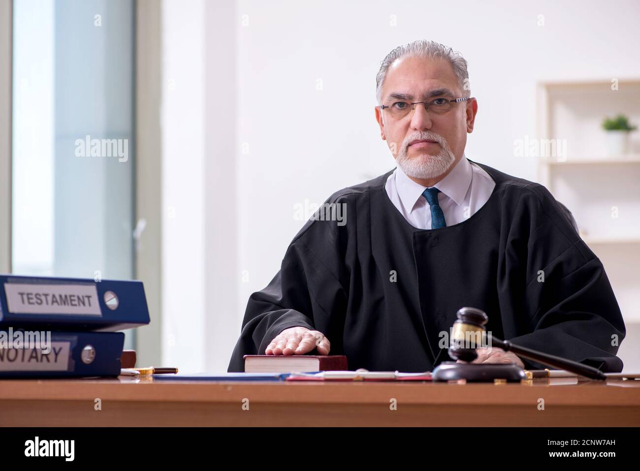Old male judge working in the courthouse Stock Photo - Alamy