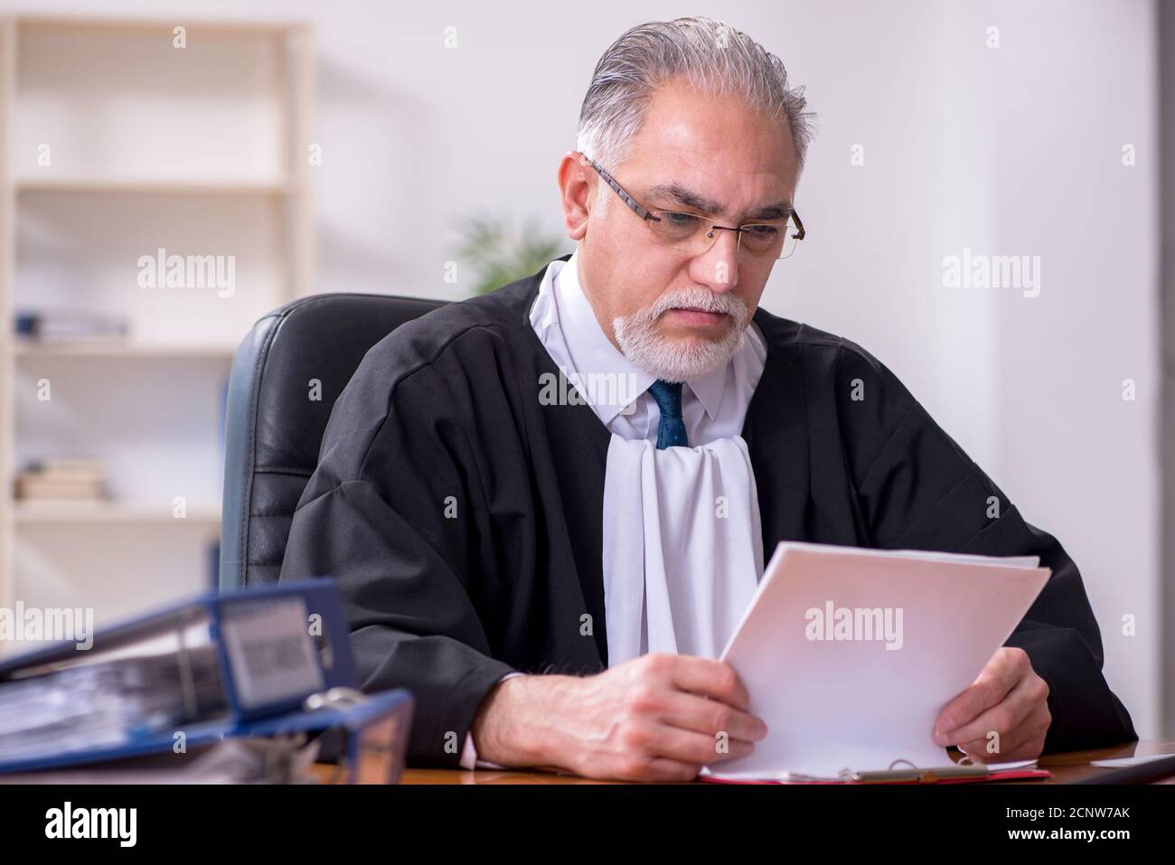 Old male judge working in the courthouse Stock Photo - Alamy