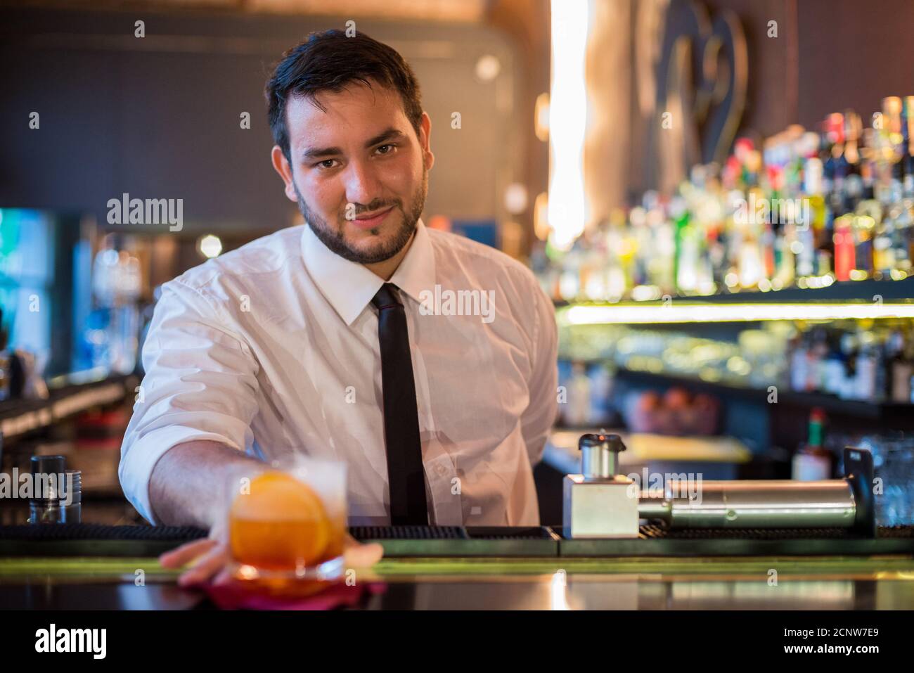 Bartender preparing and serving a special drink Stock Photo - Alamy