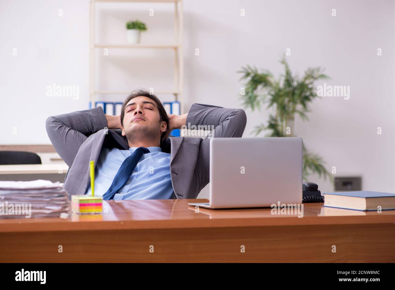Young employee sleeping in the office Stock Photo - Alamy