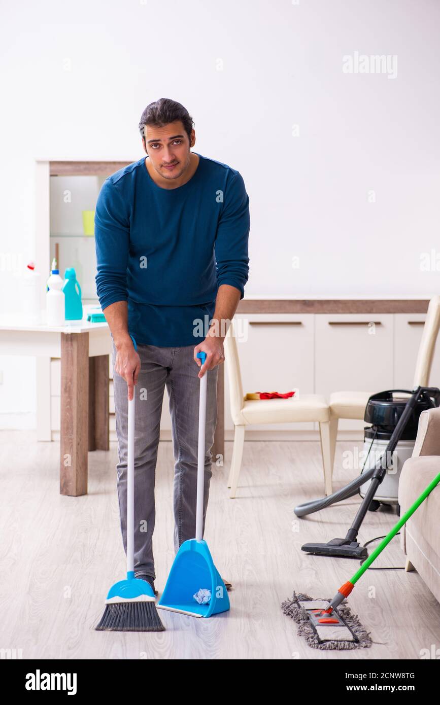 Young man husband doing housework at the home Stock Photo - Alamy