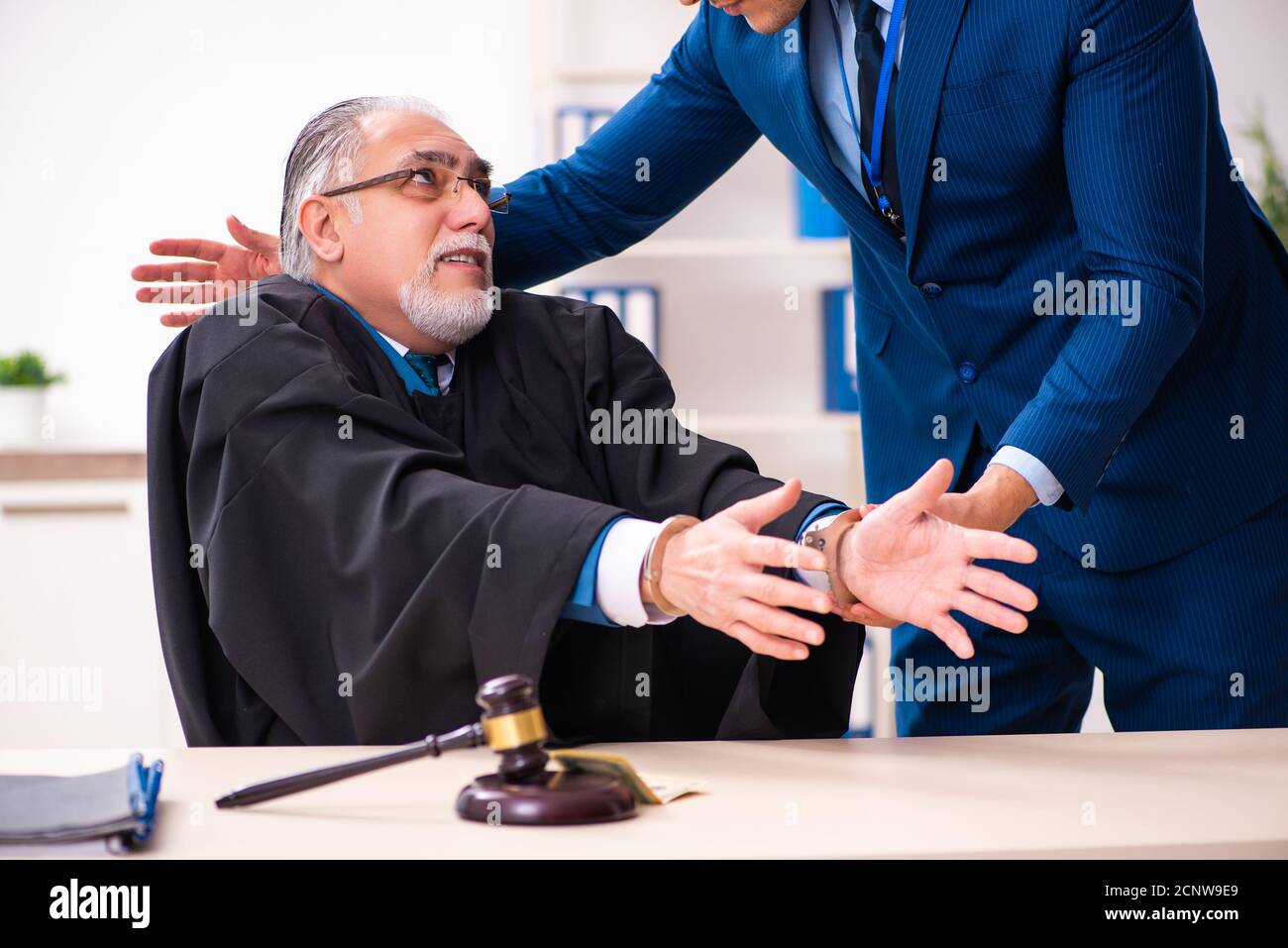 Police inspector arresting judge in court Stock Photo - Alamy