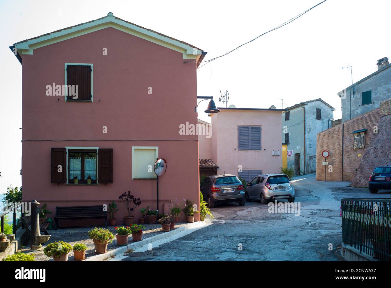 Montefelcino, red house facade, parked cars, brands, Italy, summer ...