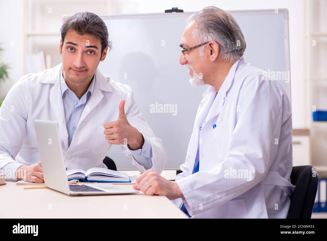 Experienced doctor teaching young assistant Stock Photo - Alamy