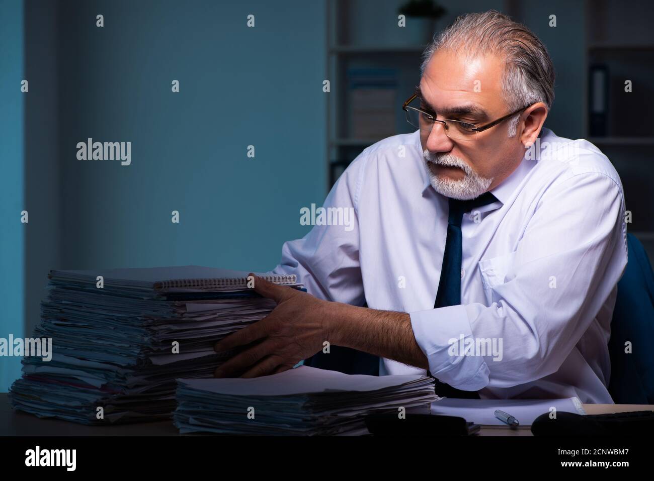 Old employee working late in the office Stock Photo - Alamy