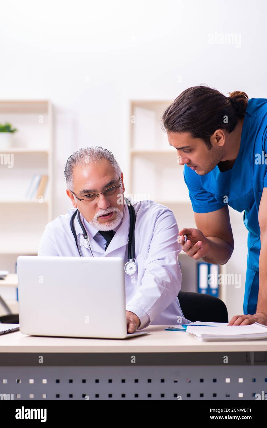 Two male doctors working in the modern clinic Stock Photo - Alamy