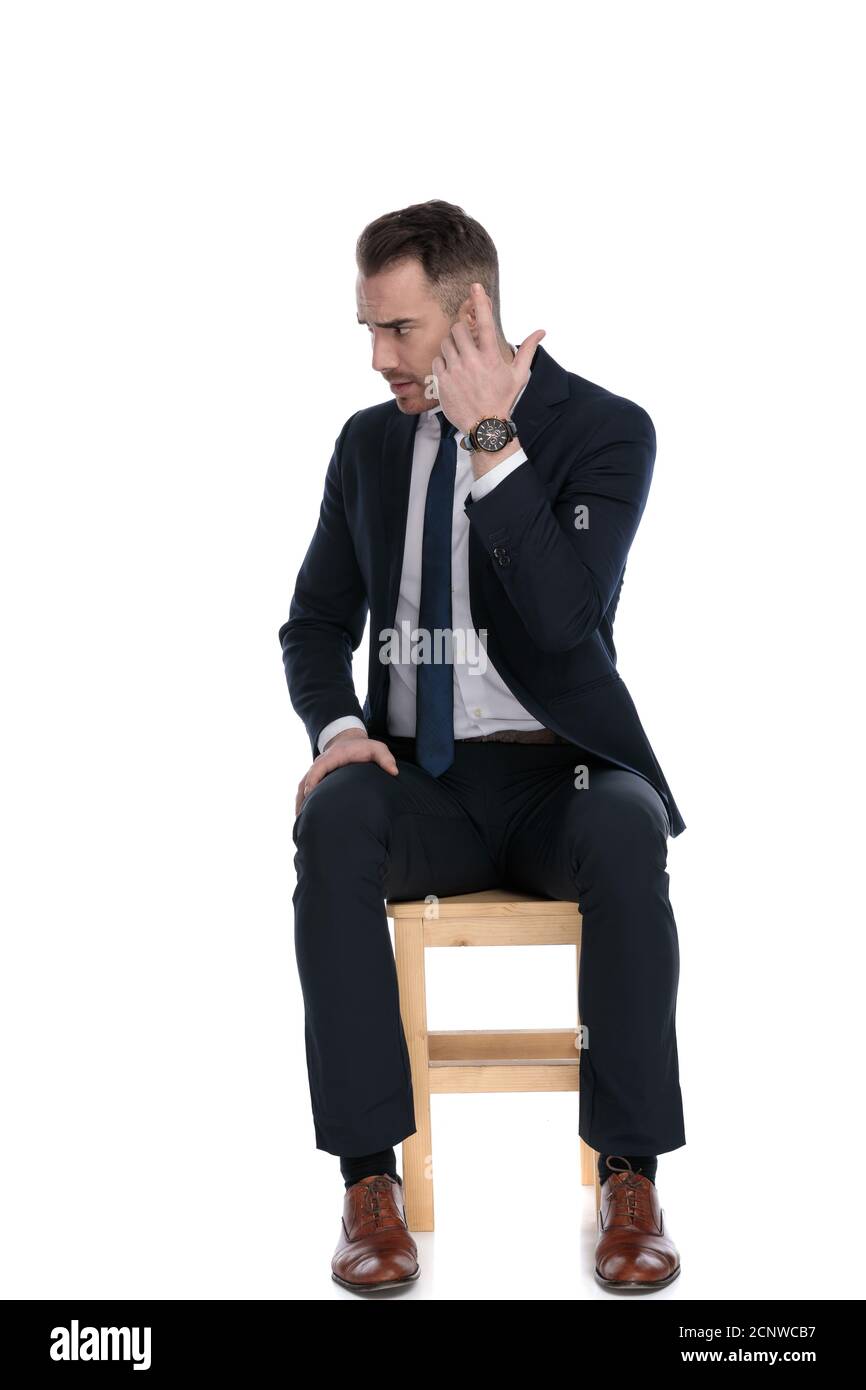 Upset businessman talking and gesturing thinking while sitting on a ...