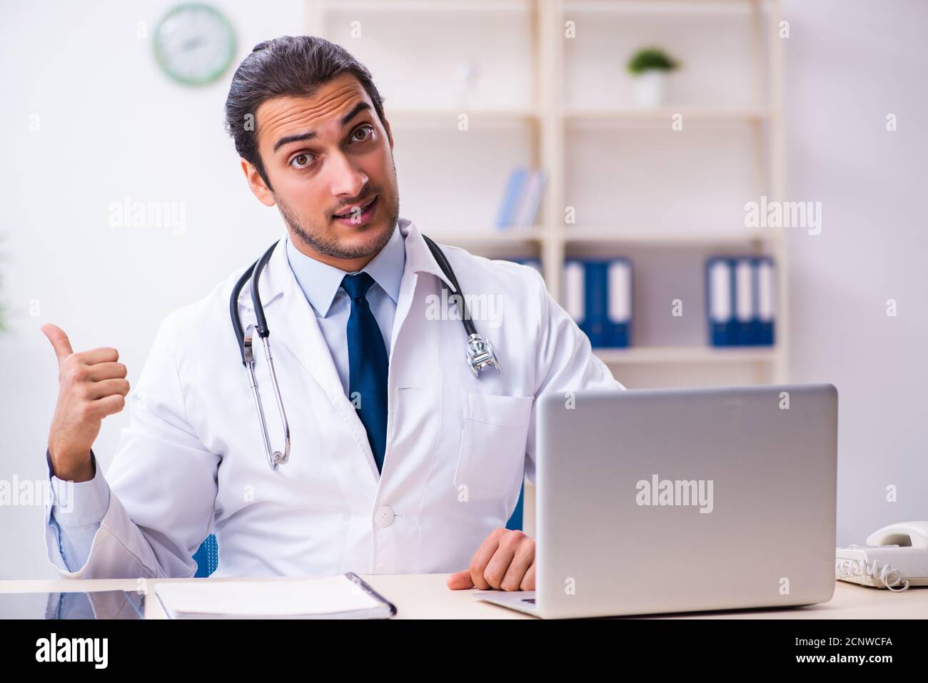 Handsome doctor giving thumb up hi-res stock photography and images - Alamy