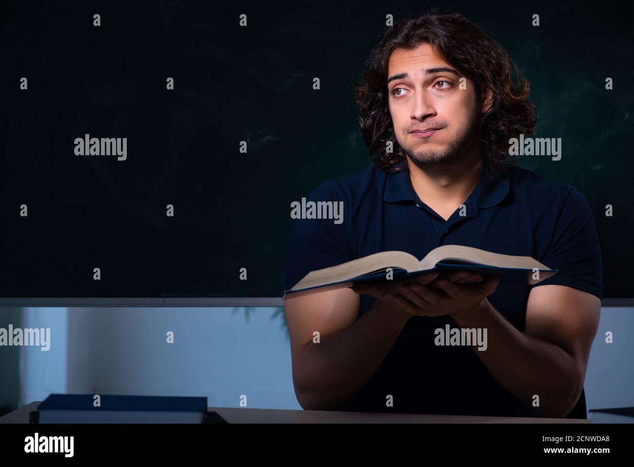 Young student in the classroom at night Stock Photo - Alamy