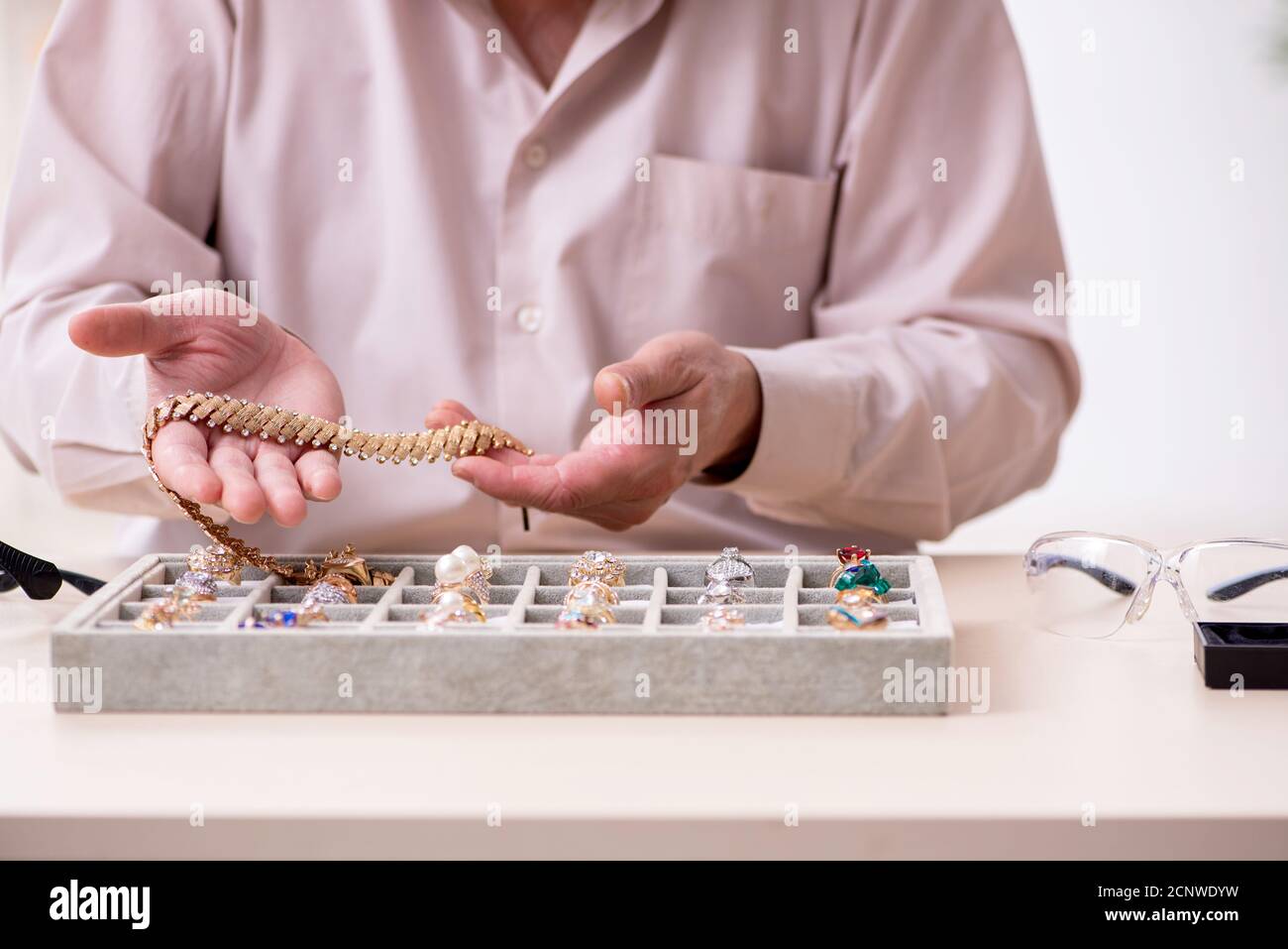 Old jeweler at the workshop Stock Photo - Alamy