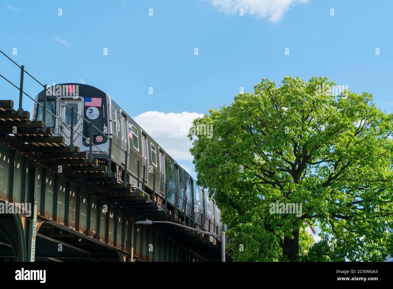 New York City subway runs on the elevated railway track at Queens New ...
